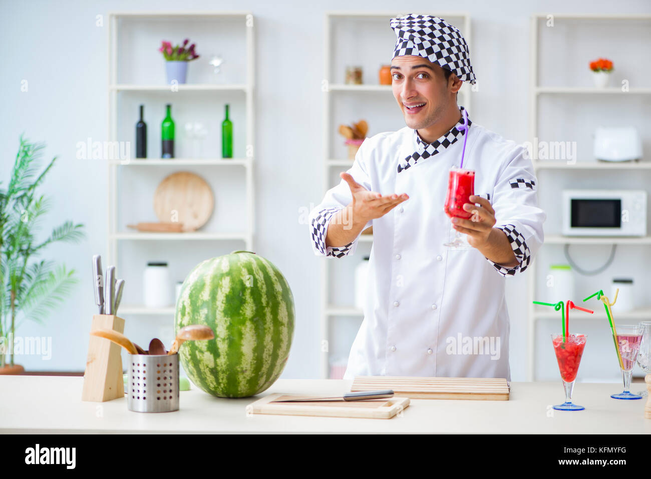 Male cook with watermelon in kitchen Stock Photo - Alamy