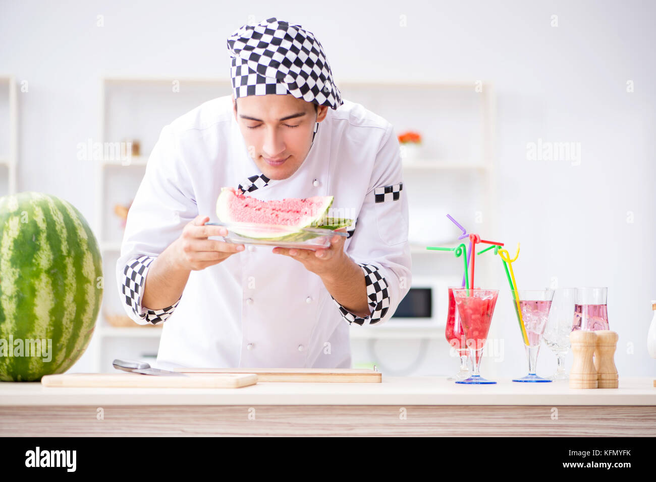 Male cook with watermelon in kitchen Stock Photo - Alamy