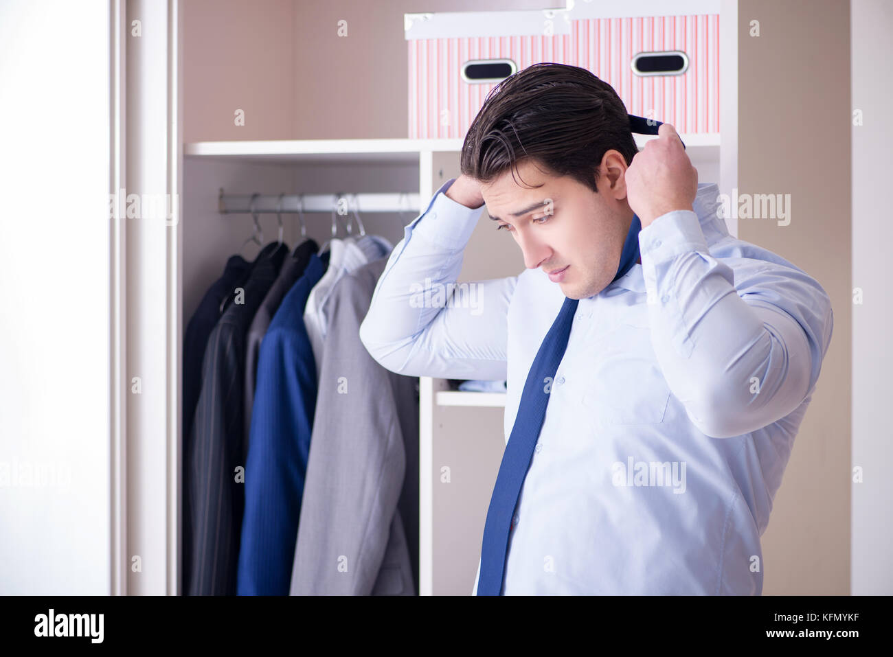 Young man businessman getting dressed for work Stock Photo - Alamy