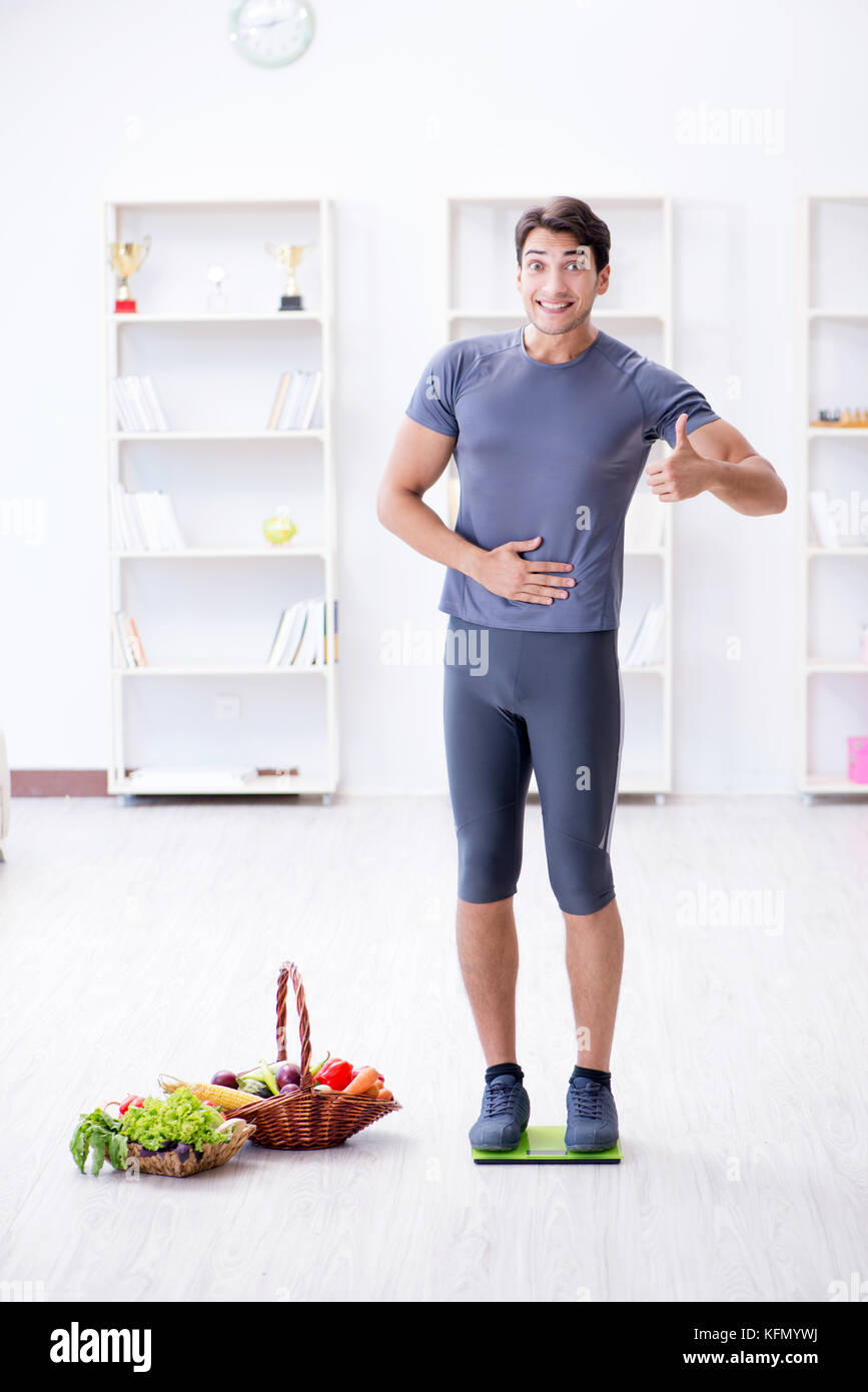 Man promoting the benefits of healthy eating and doing sports Stock ...