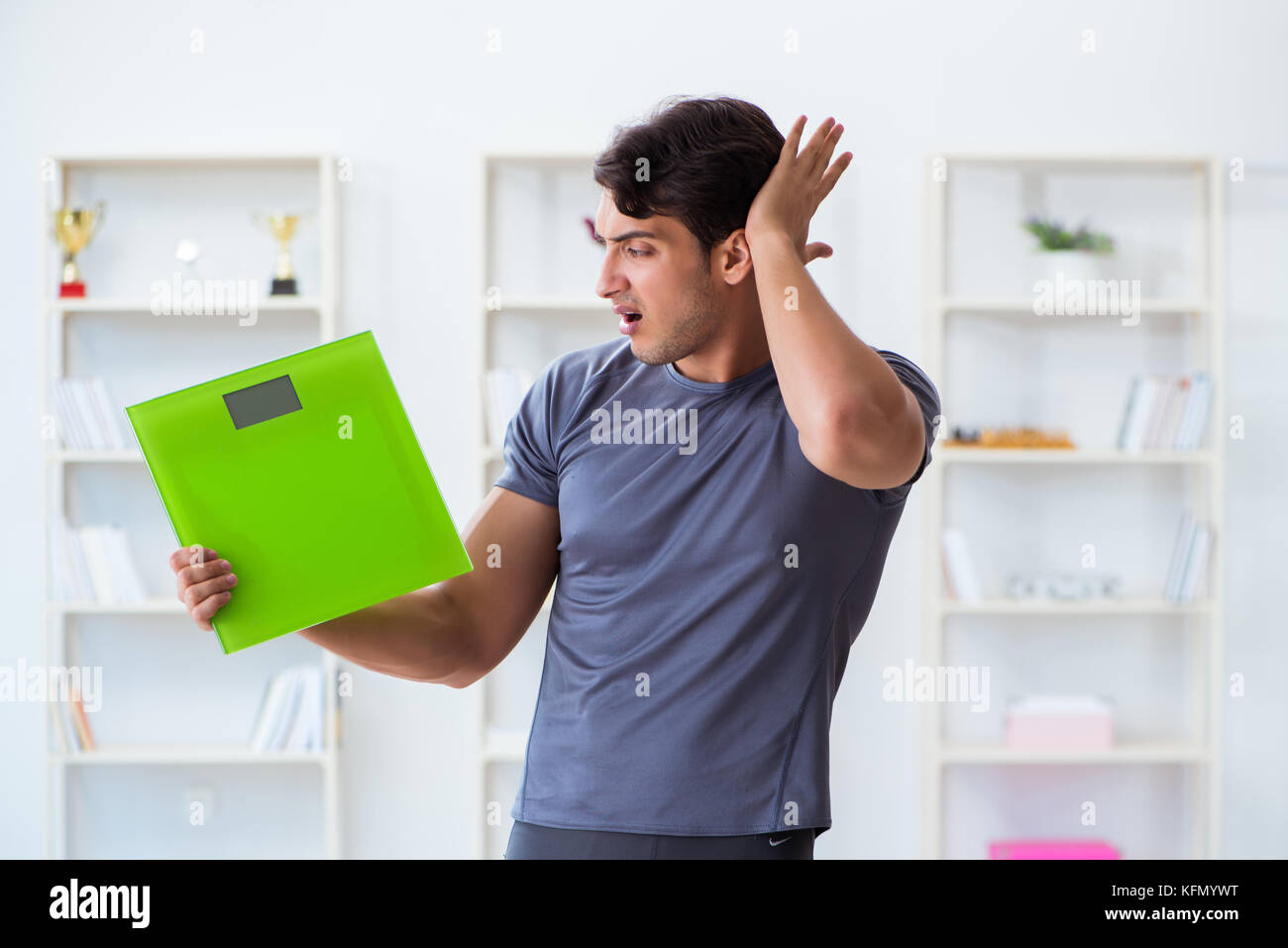 Man with scales in sports and health concept Stock Photo - Alamy