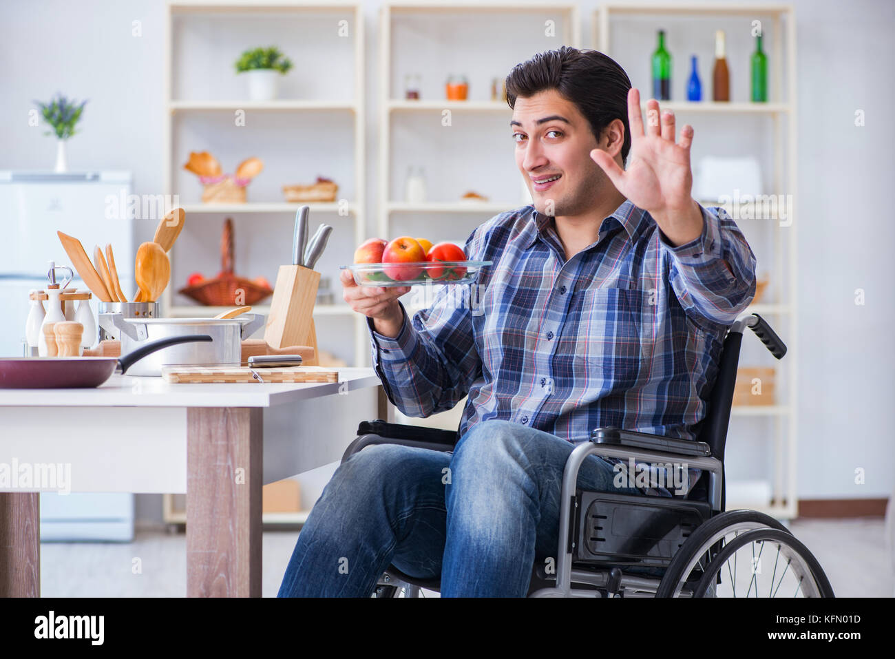 Young disabled husband preparing food salad Stock Photo - Alamy