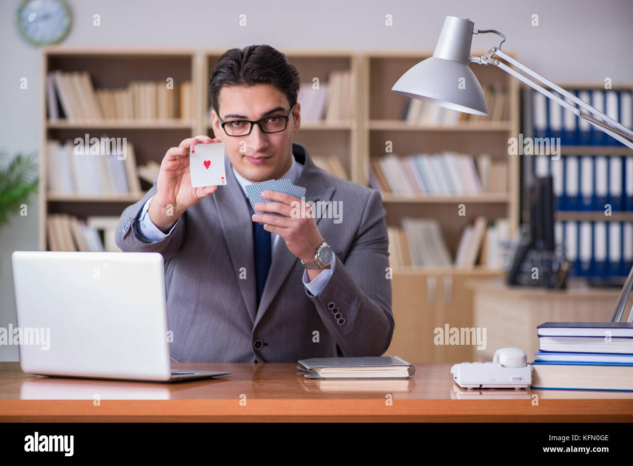 Businessman gambling playing cards at work Stock Photo - Alamy