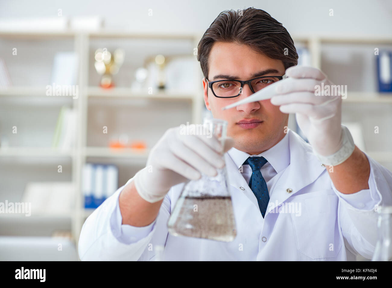 Young researcher scientist doing a water test contamination experiment ...