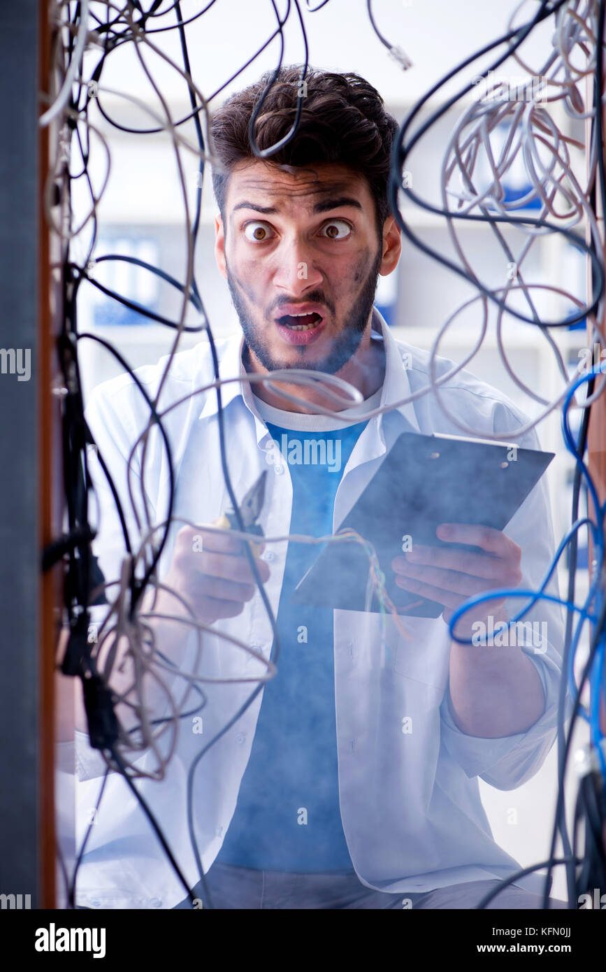 Electrician trying to untangle wires in repair concept Stock Photo - Alamy
