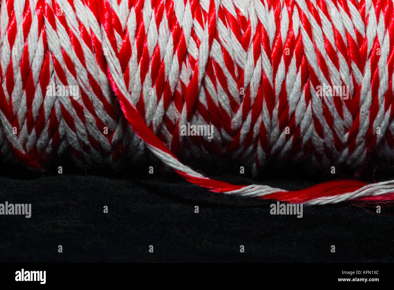 Red and white rope for the parcel bundle on black background Stock ...