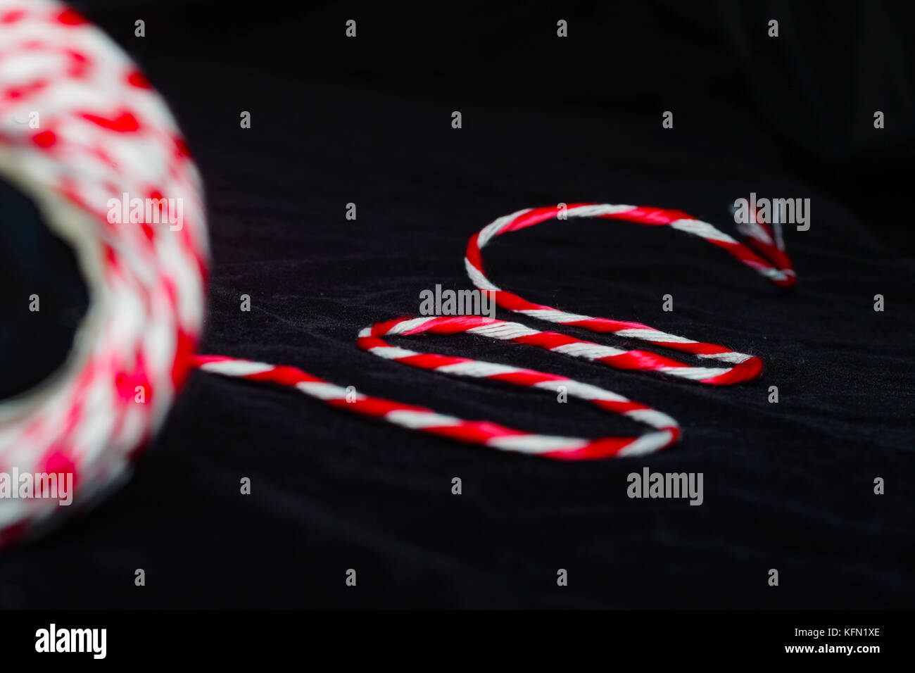 Red and white rope for the parcel bundle on black background Stock ...