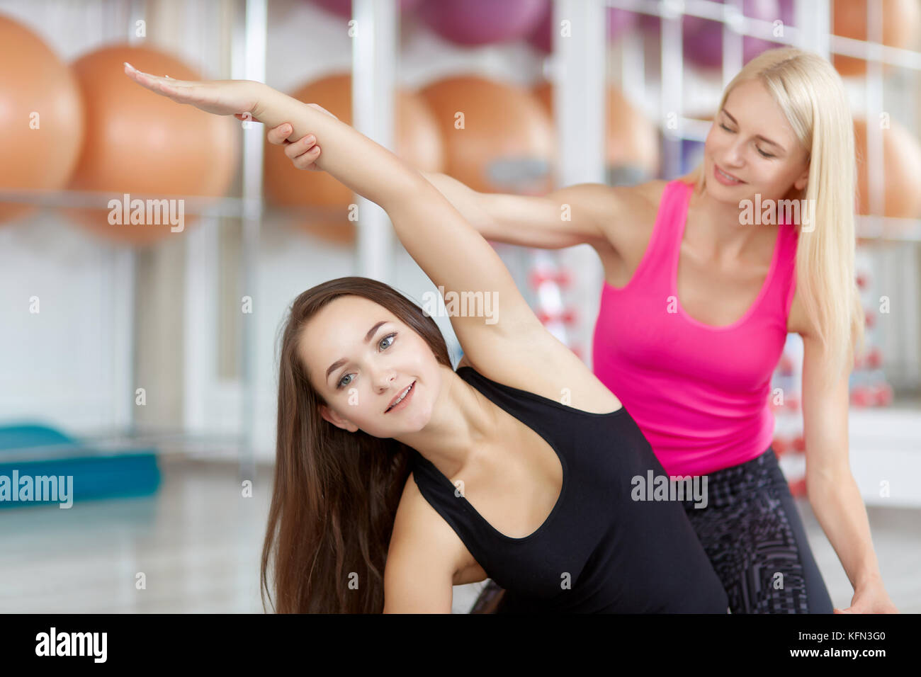 Young woman exercising with her fitness instructor Stock Photo - Alamy