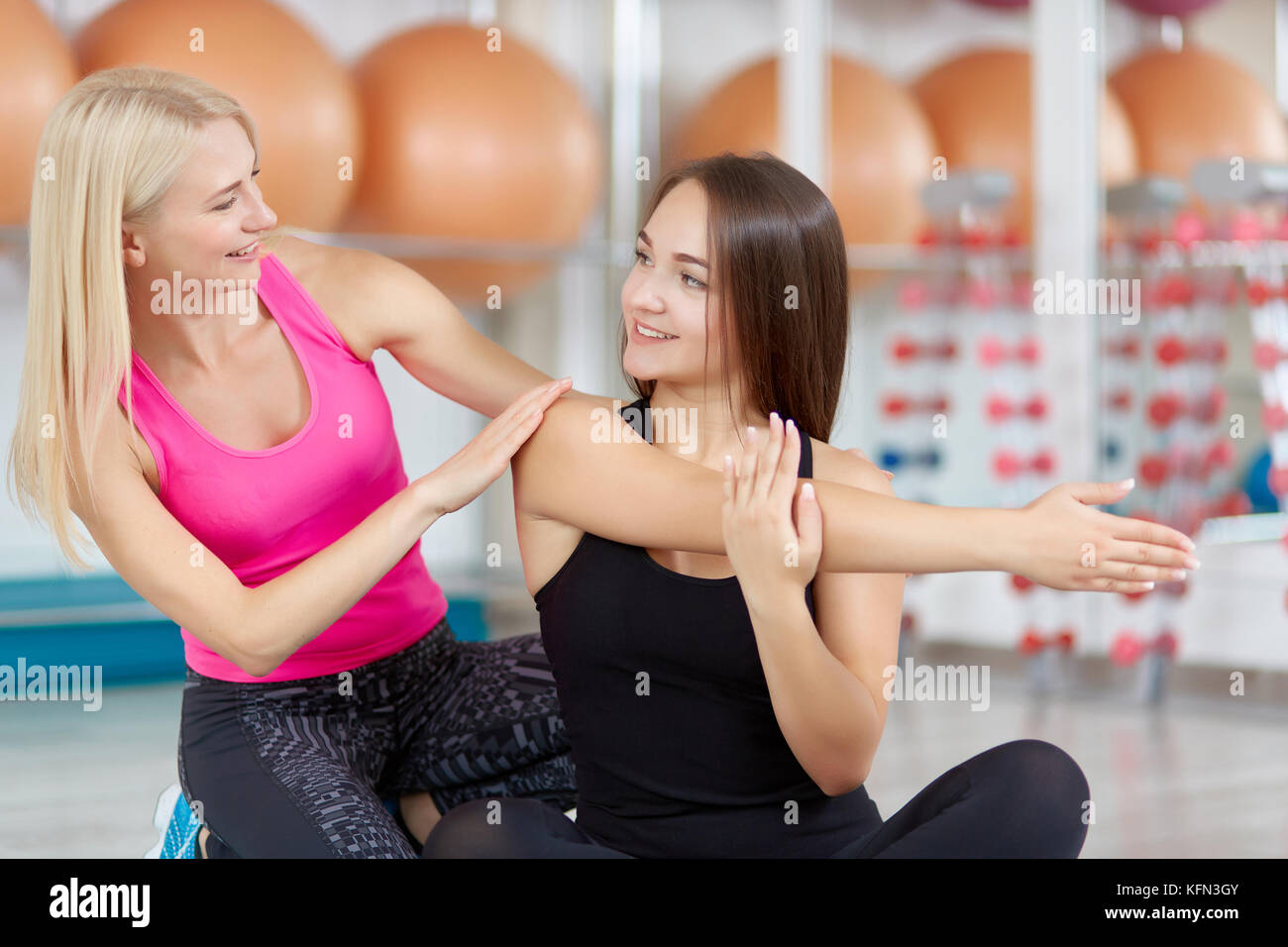 Young woman exercising with her fitness instructor Stock Photo - Alamy