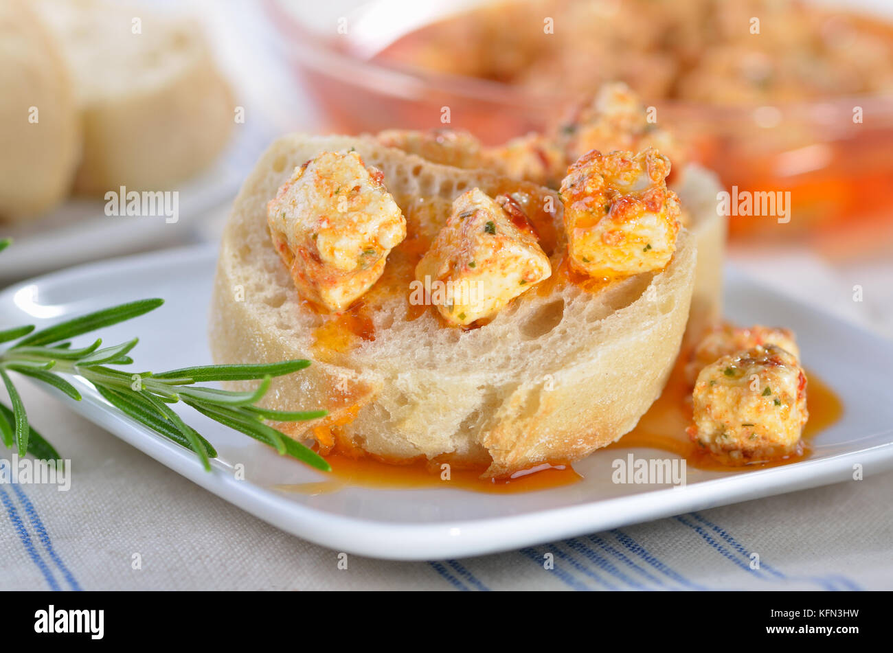 Marinated diced Greek feta cheese on slices of baguette, garnish with ...