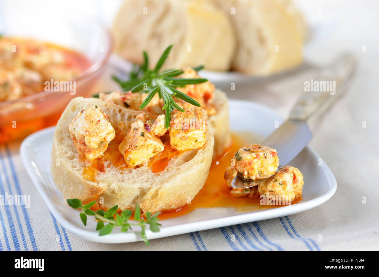 Marinated diced Greek feta cheese on slices of baguette, garnish with ...