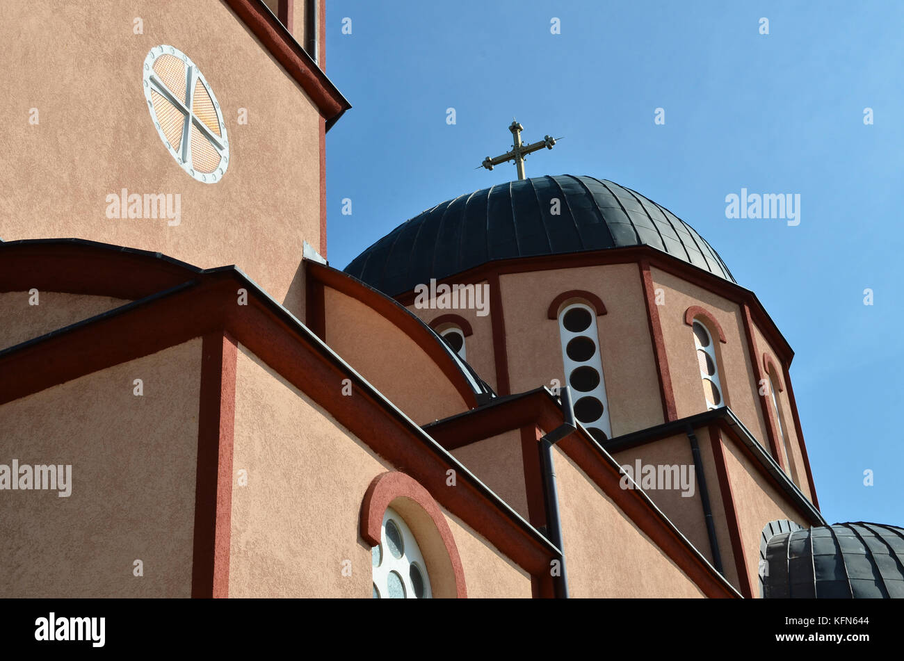 Orthodox church with orange walls and cross and windows Stock Photo - Alamy