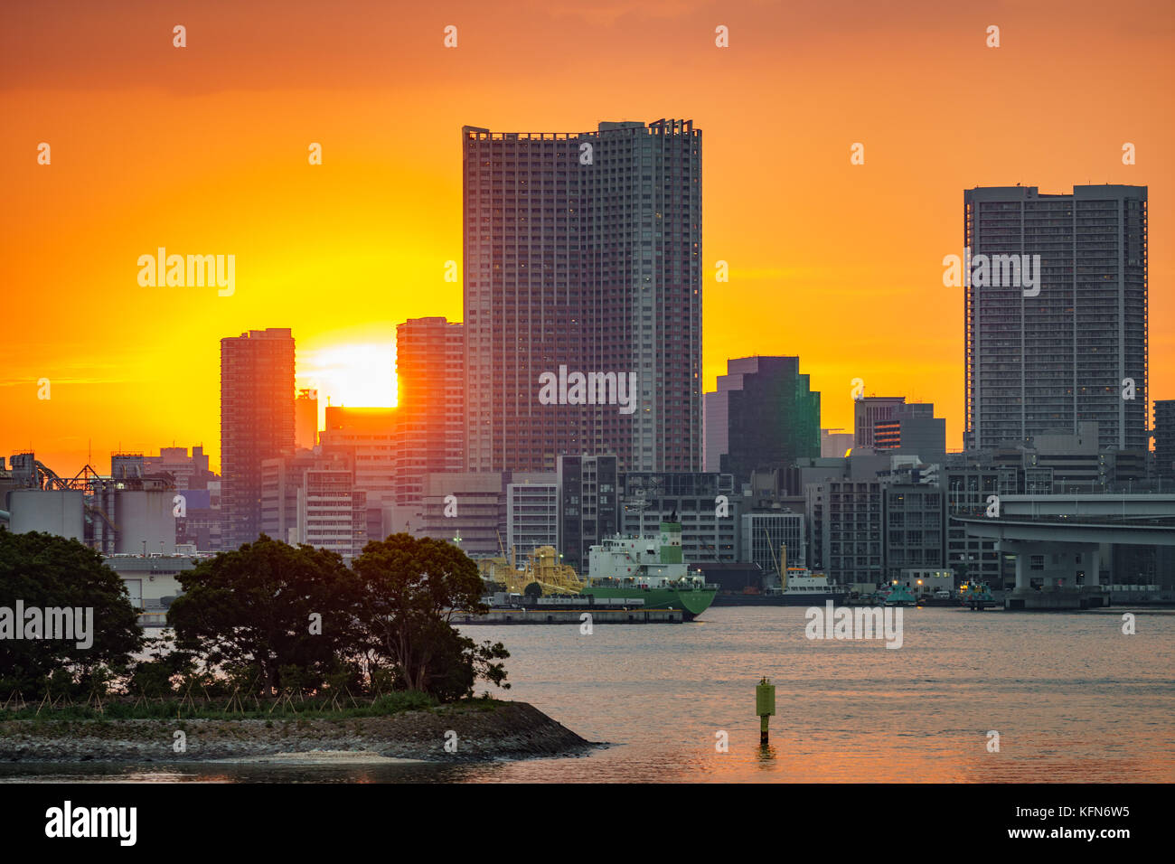 Sunset over office buildings in Tokyo with water reflection Stock Photo ...