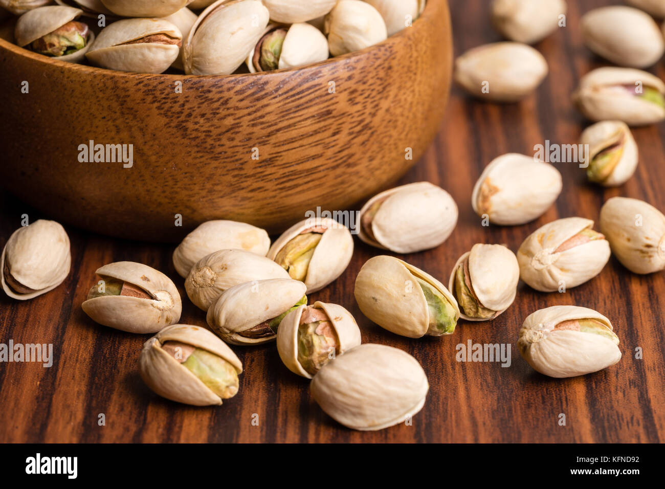 Pistachios nuts in shell on wooden bowl Stock Photo - Alamy