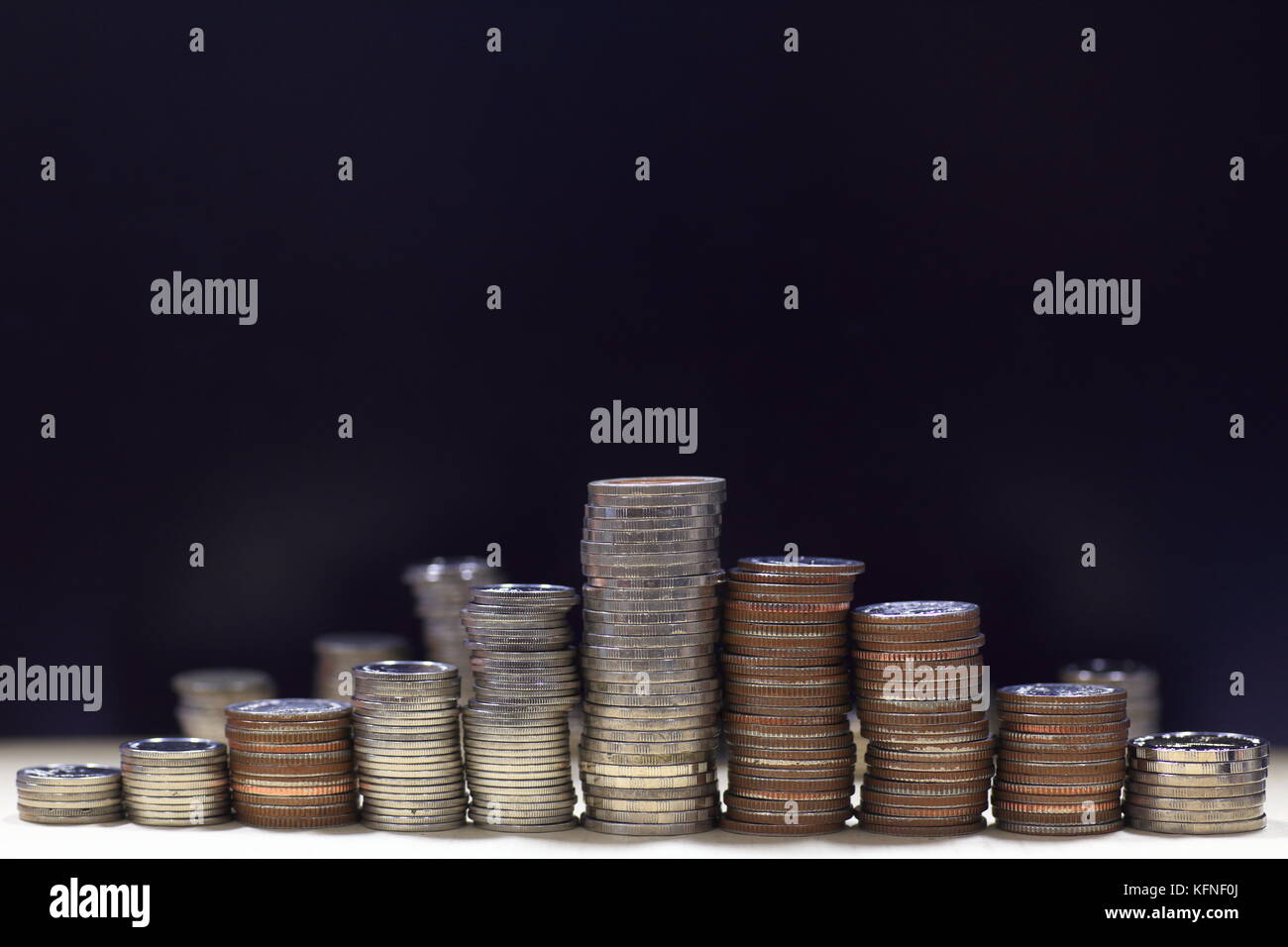 isolated coin stack in pyramid shape graph on black background Stock ...