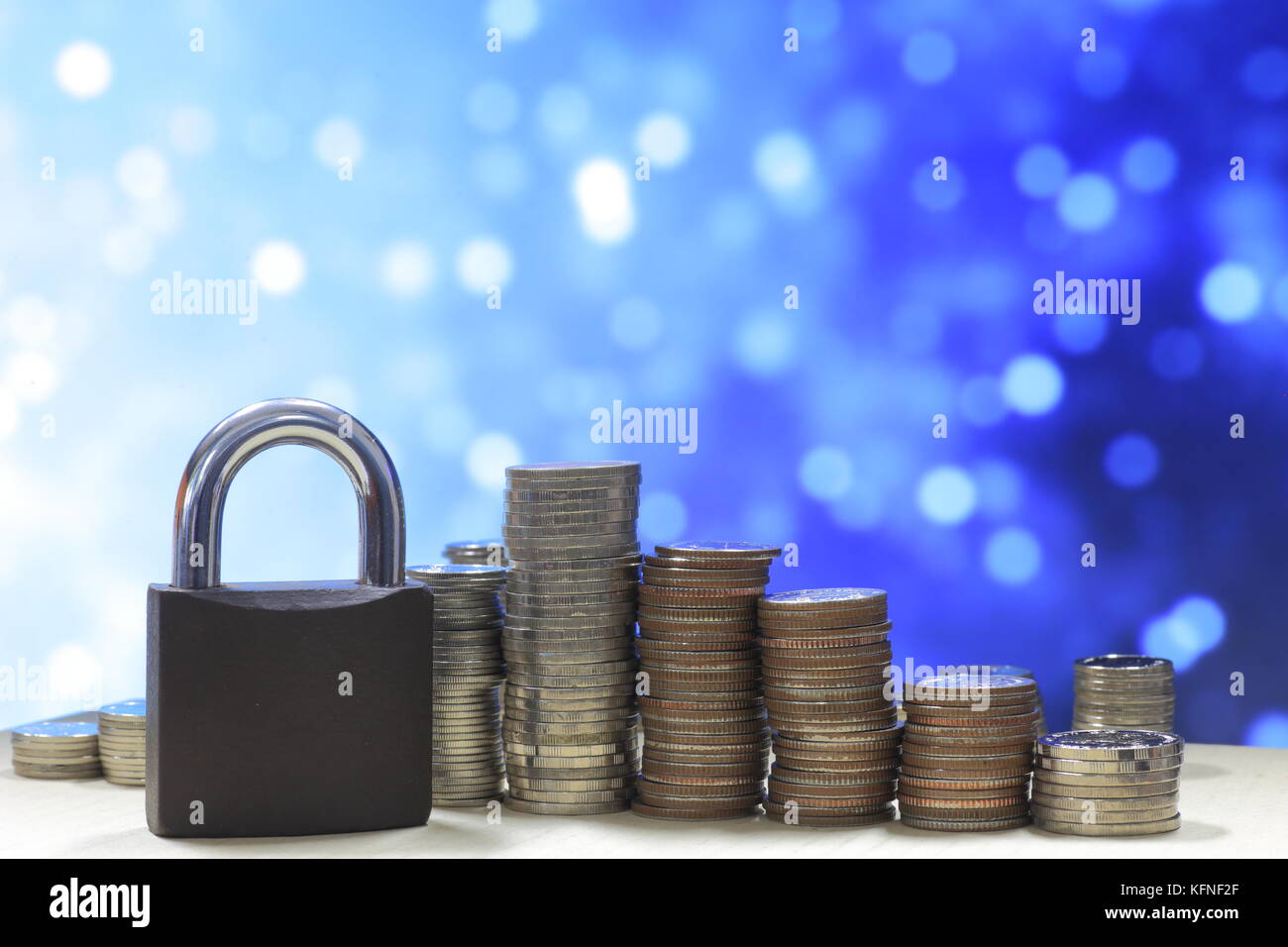 Coin money stack and lock, on blue light background. Saving and ...