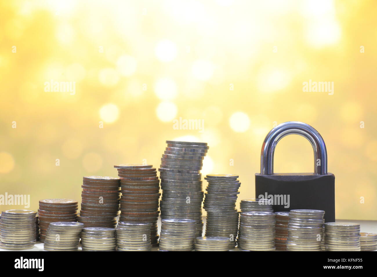 Coin money stack and lock, on gold light background. Saving and ...