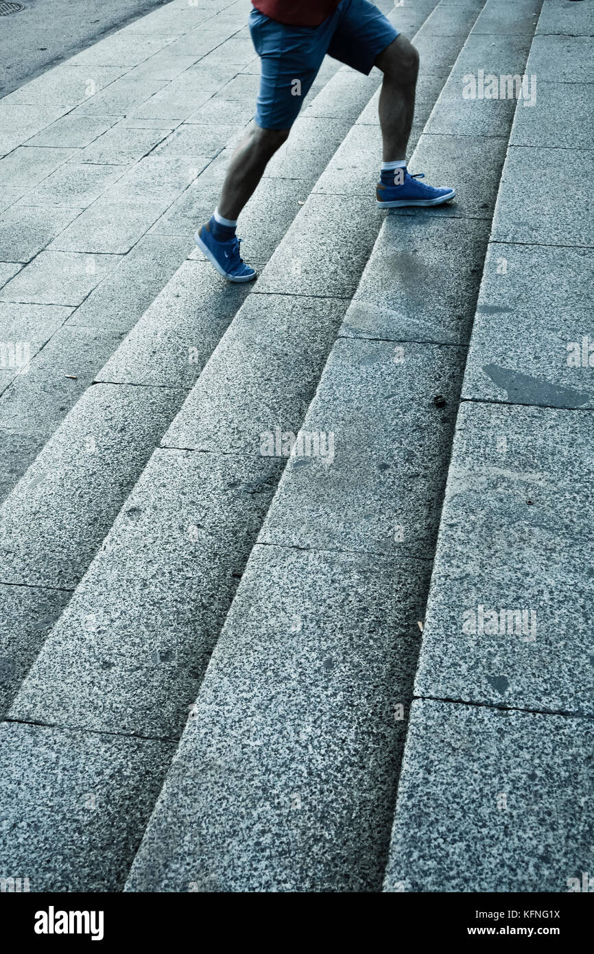 Man walking upstairs on staircase Stock Photo - Alamy