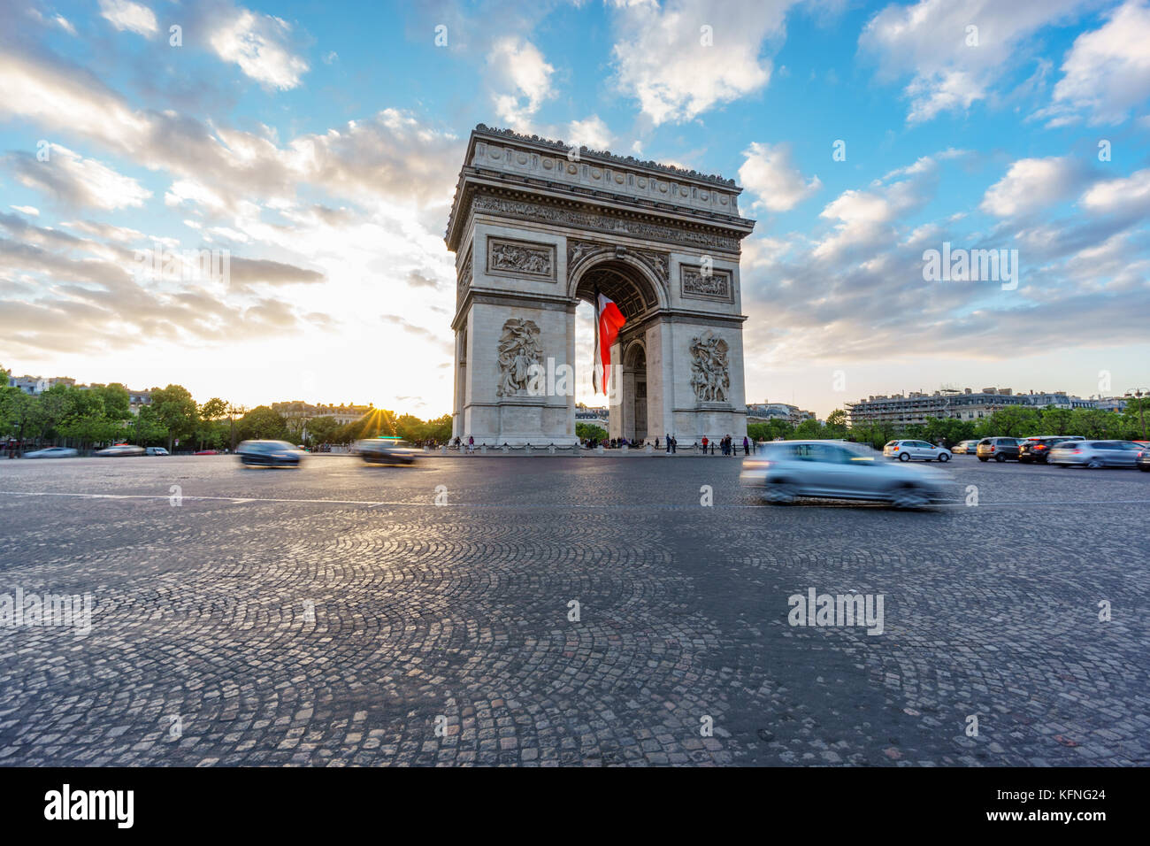 Wide Arc de Triomphe and blurred traffic at sunset Stock Photo - Alamy