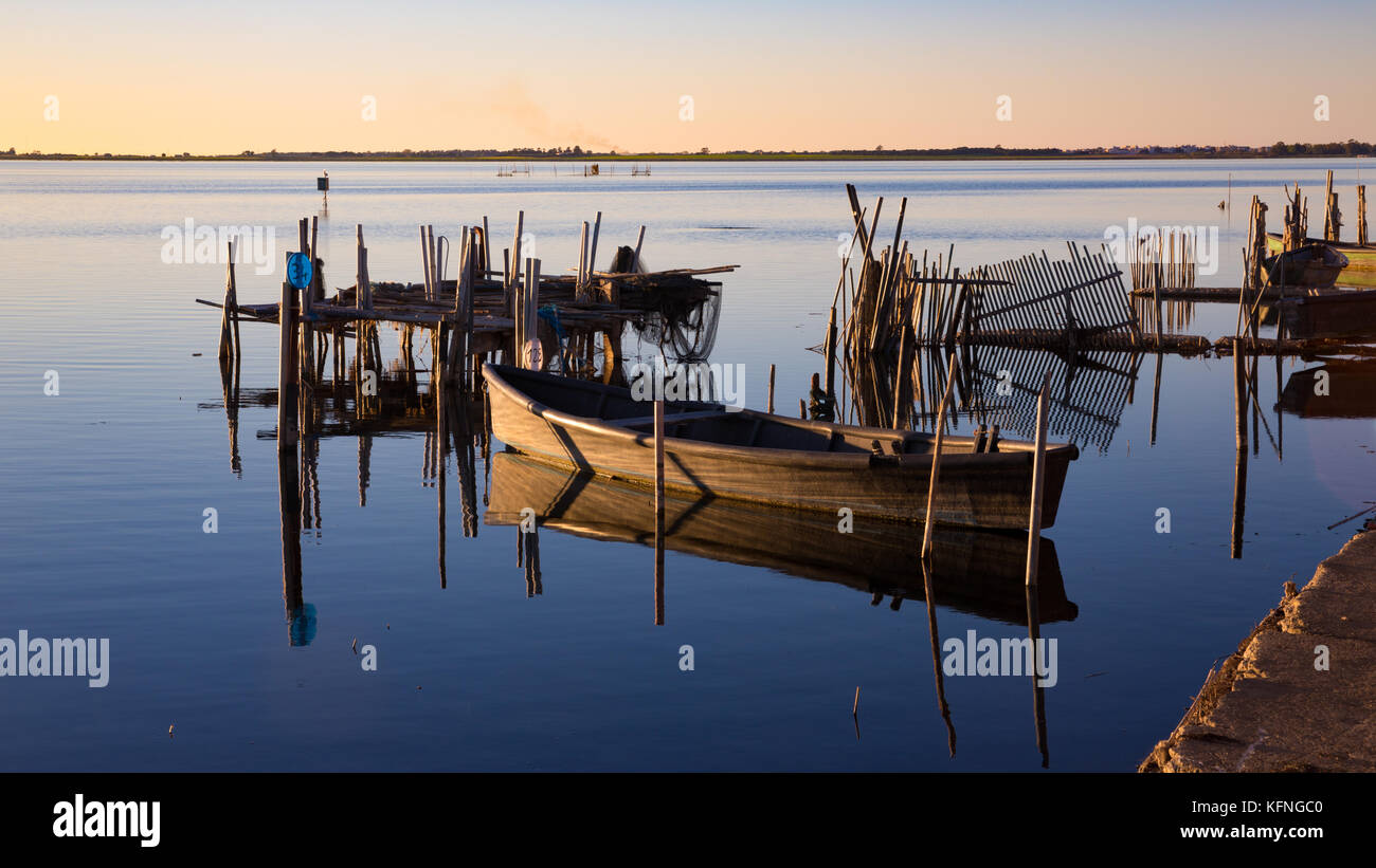 Lesina (Puglia, Italy) - View of the lake and boats in the sunset Stock ...