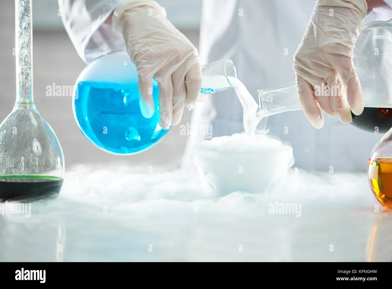 Cropped close up of a professional chemist in a labcoat conducting an ...