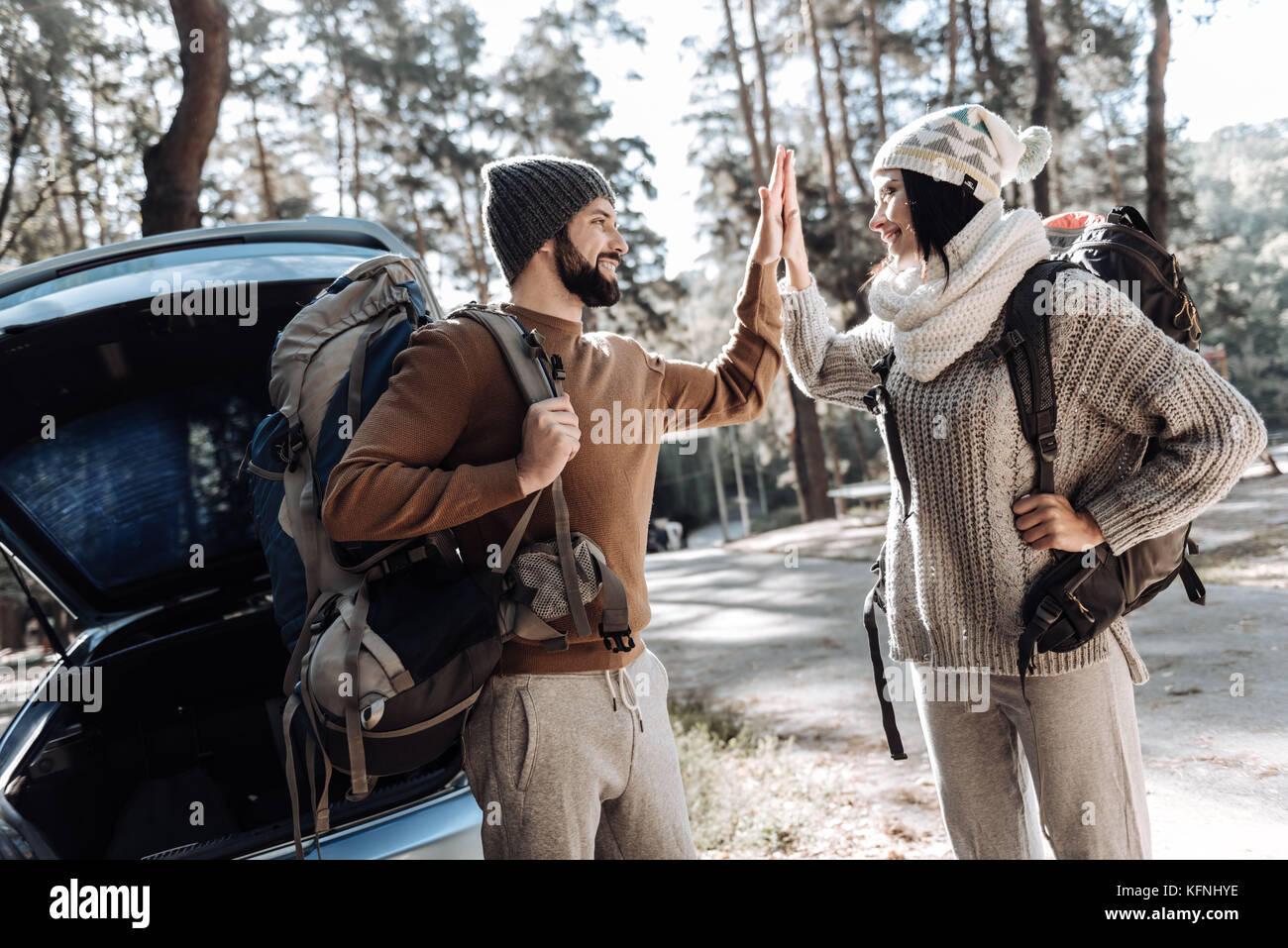 Cheerful friends giving high five Stock Photo - Alamy