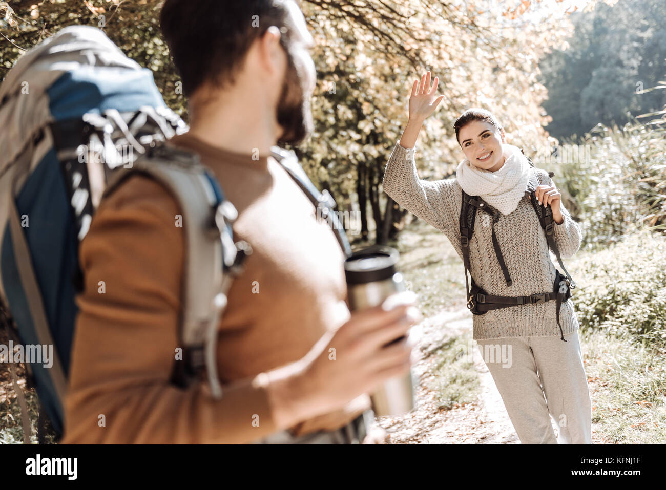 Cheerful girl waving good bye to her boyfriend Stock Photo - Alamy