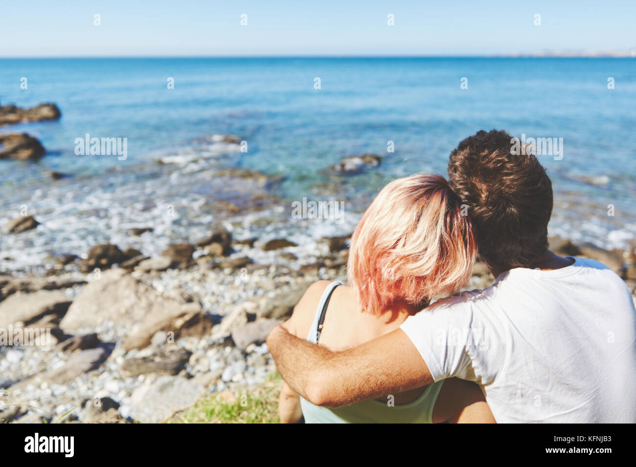 Back portrait of couple cuddling at the seaside Stock Photo - Alamy
