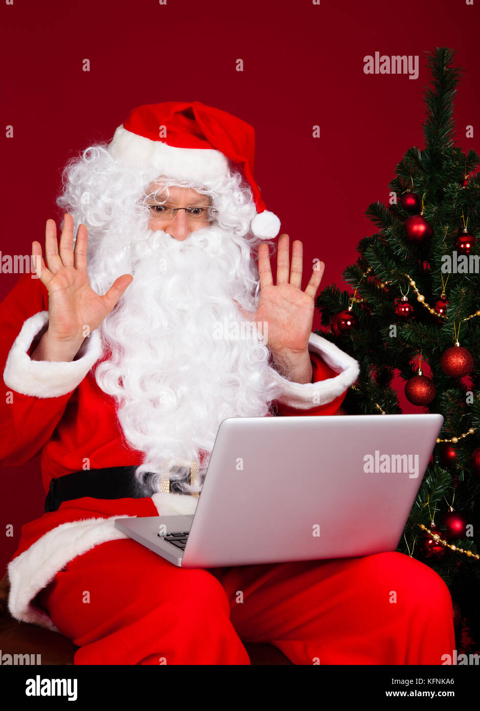 Portrait of santa looking at laptop over white background Stock Photo ...