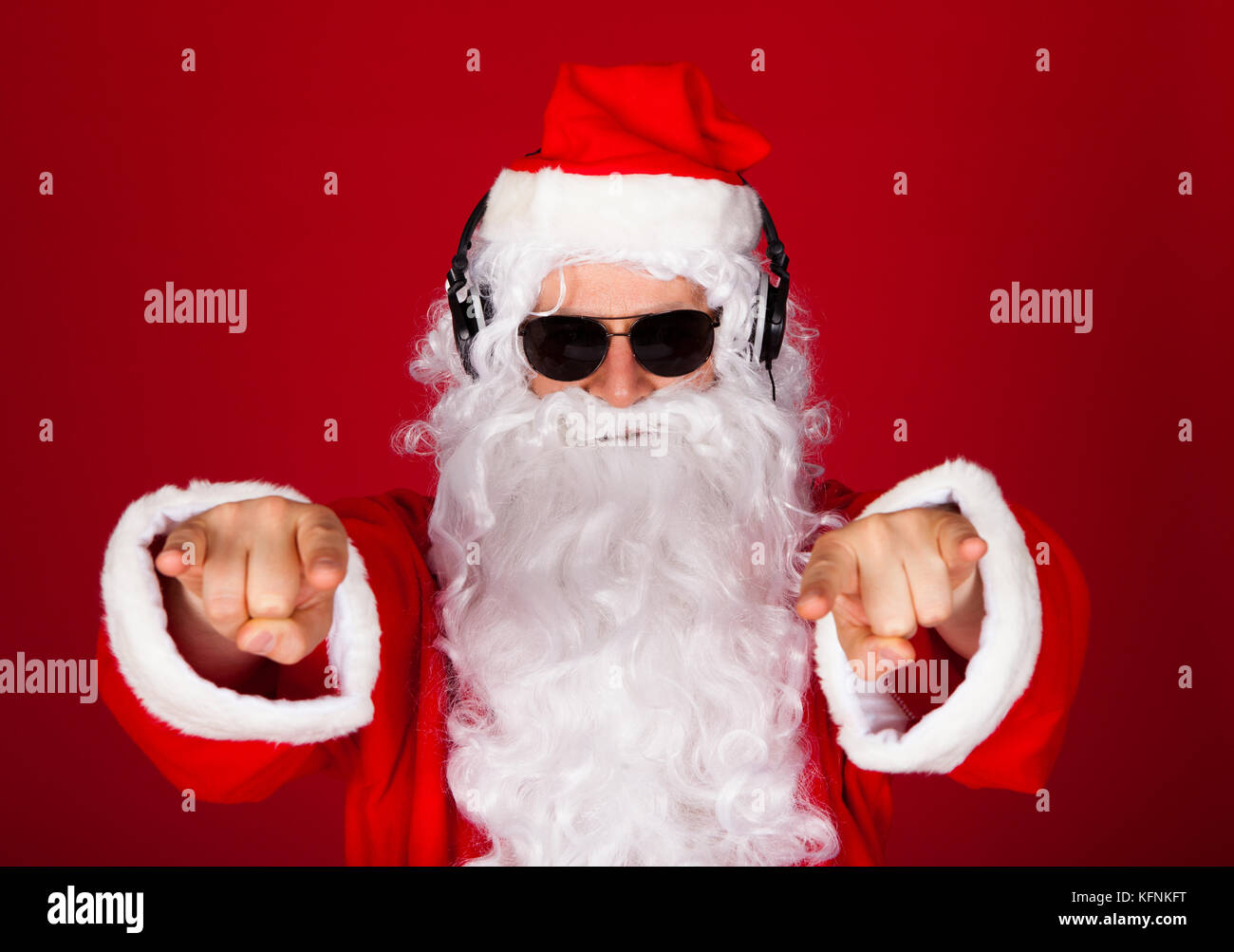 Portrait of a santa listening music and gesturing Stock Photo - Alamy