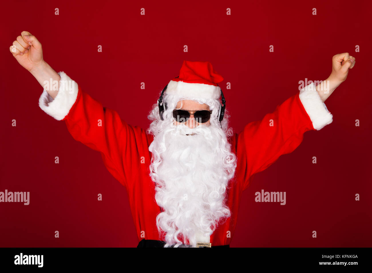 Portrait of excited santa raising his arms on red background Stock ...