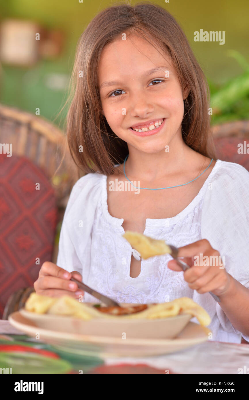 girl eating meat pockets Stock Photo - Alamy
