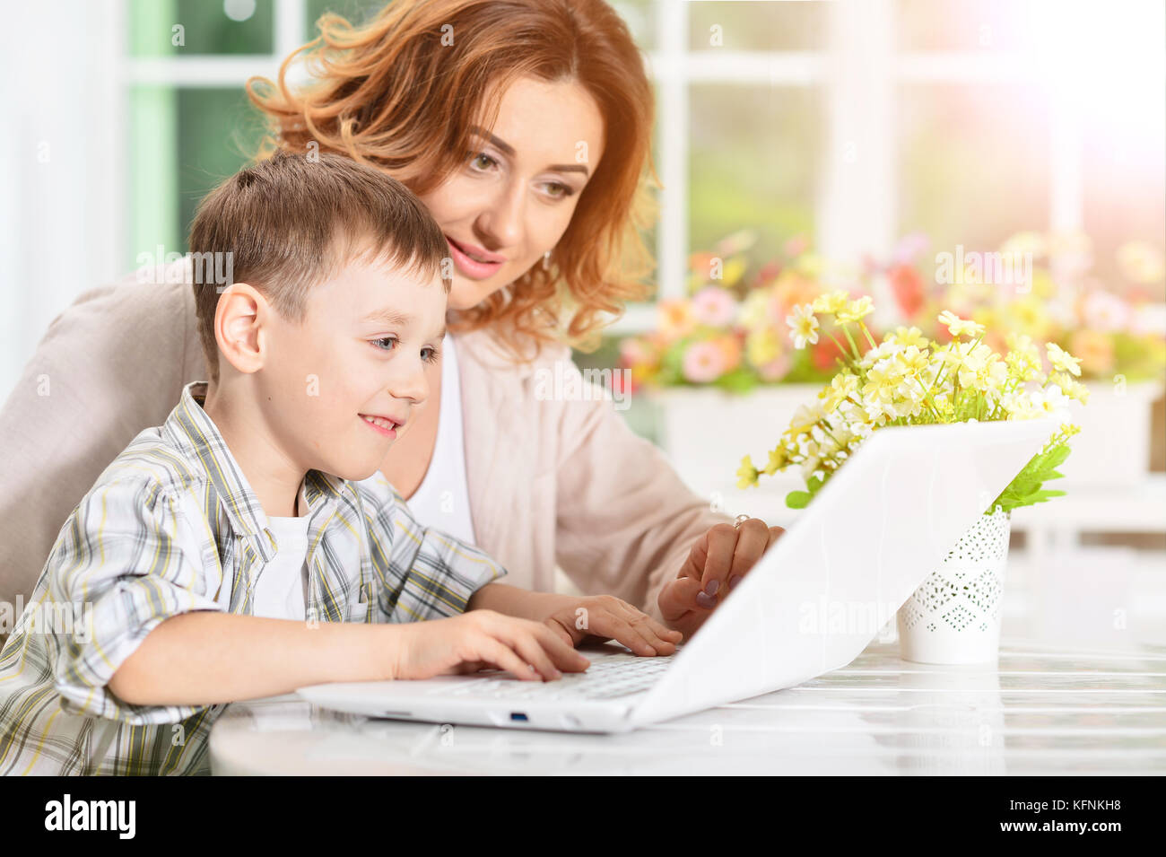 Mother and son using laptop Stock Photo - Alamy