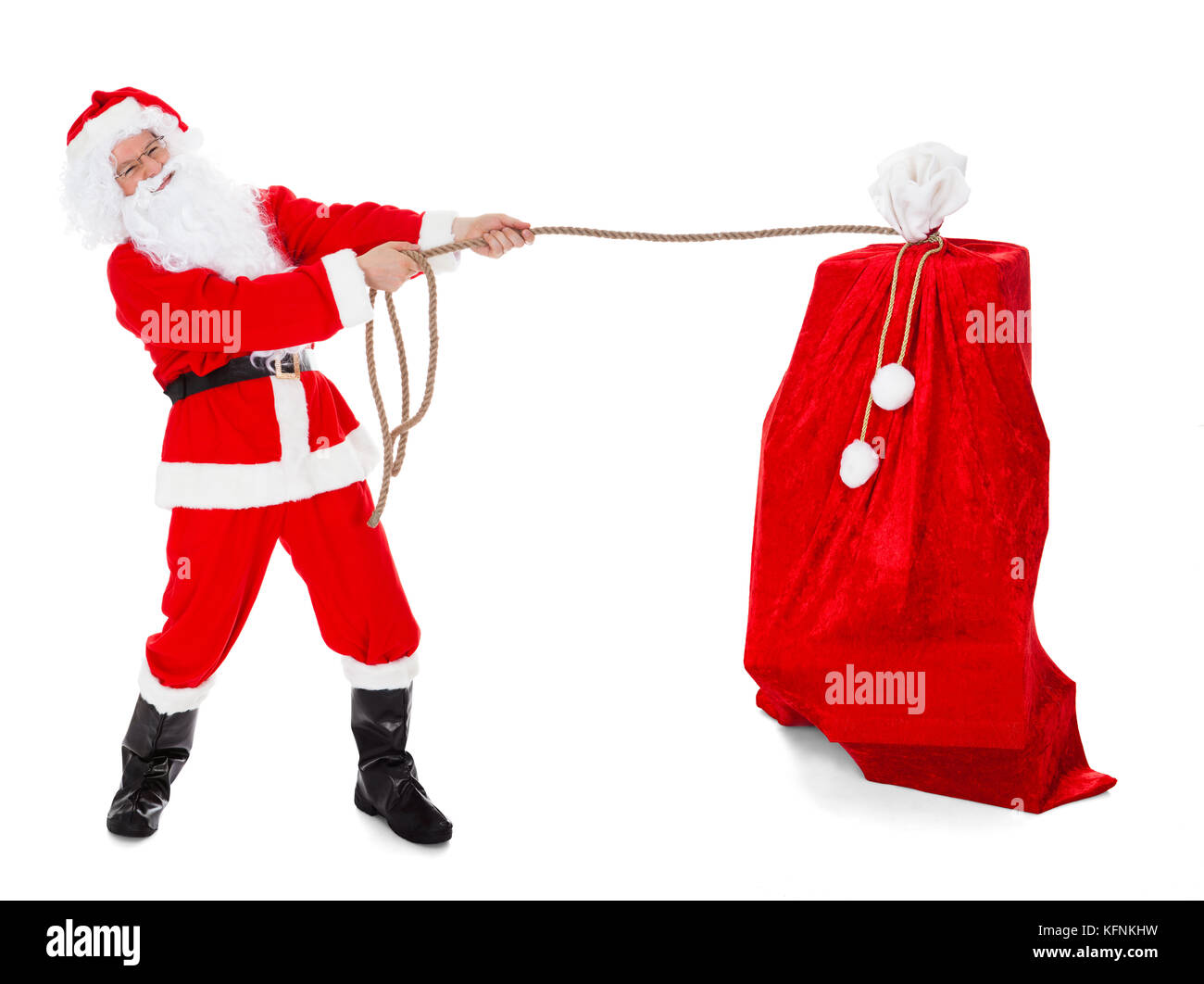 Santa pulling gifts sack over white background Stock Photo - Alamy