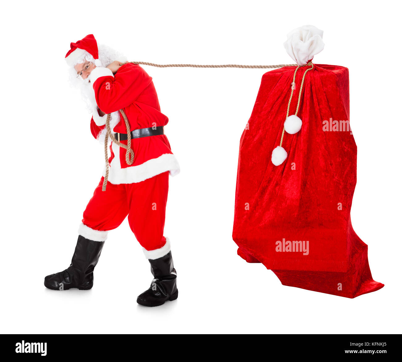 Santa pulling gifts sack over white background Stock Photo - Alamy