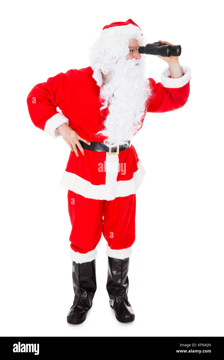 Close-up of santa looking in binocular on white background Stock Photo ...