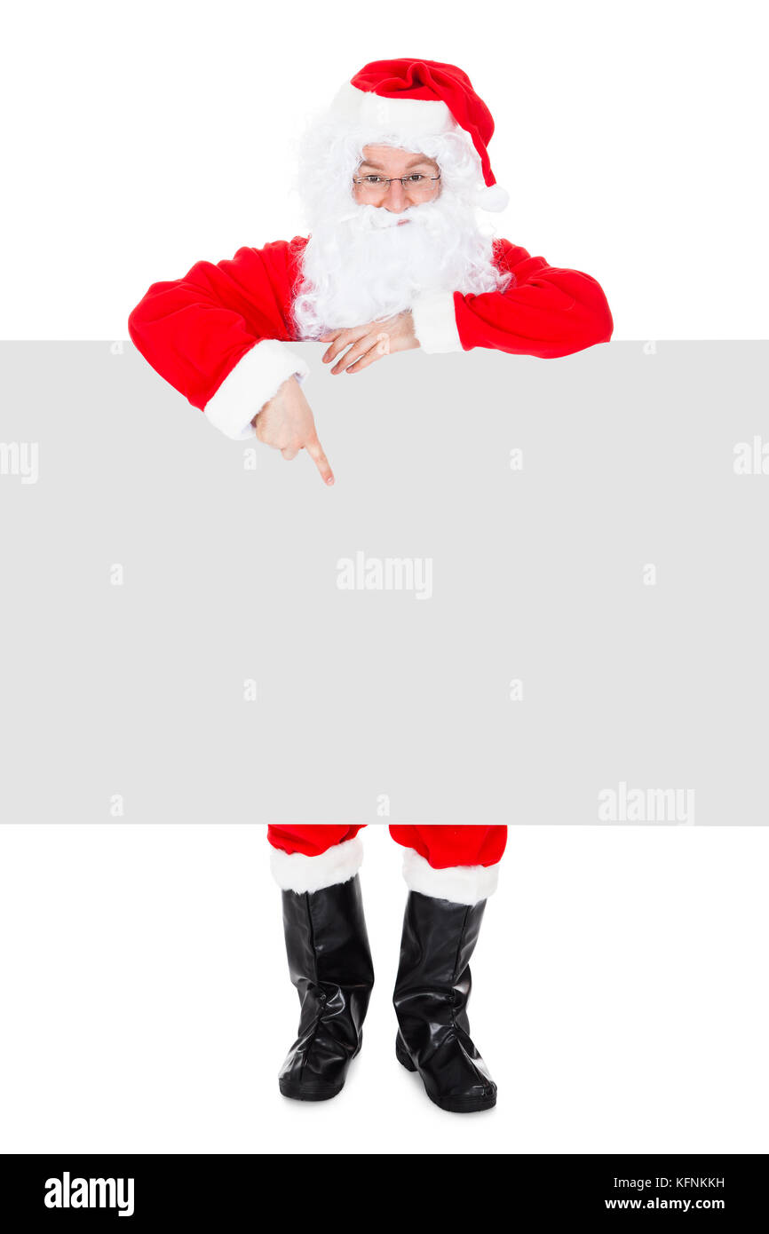 Portrait of a santa holding blank placard over white background Stock ...