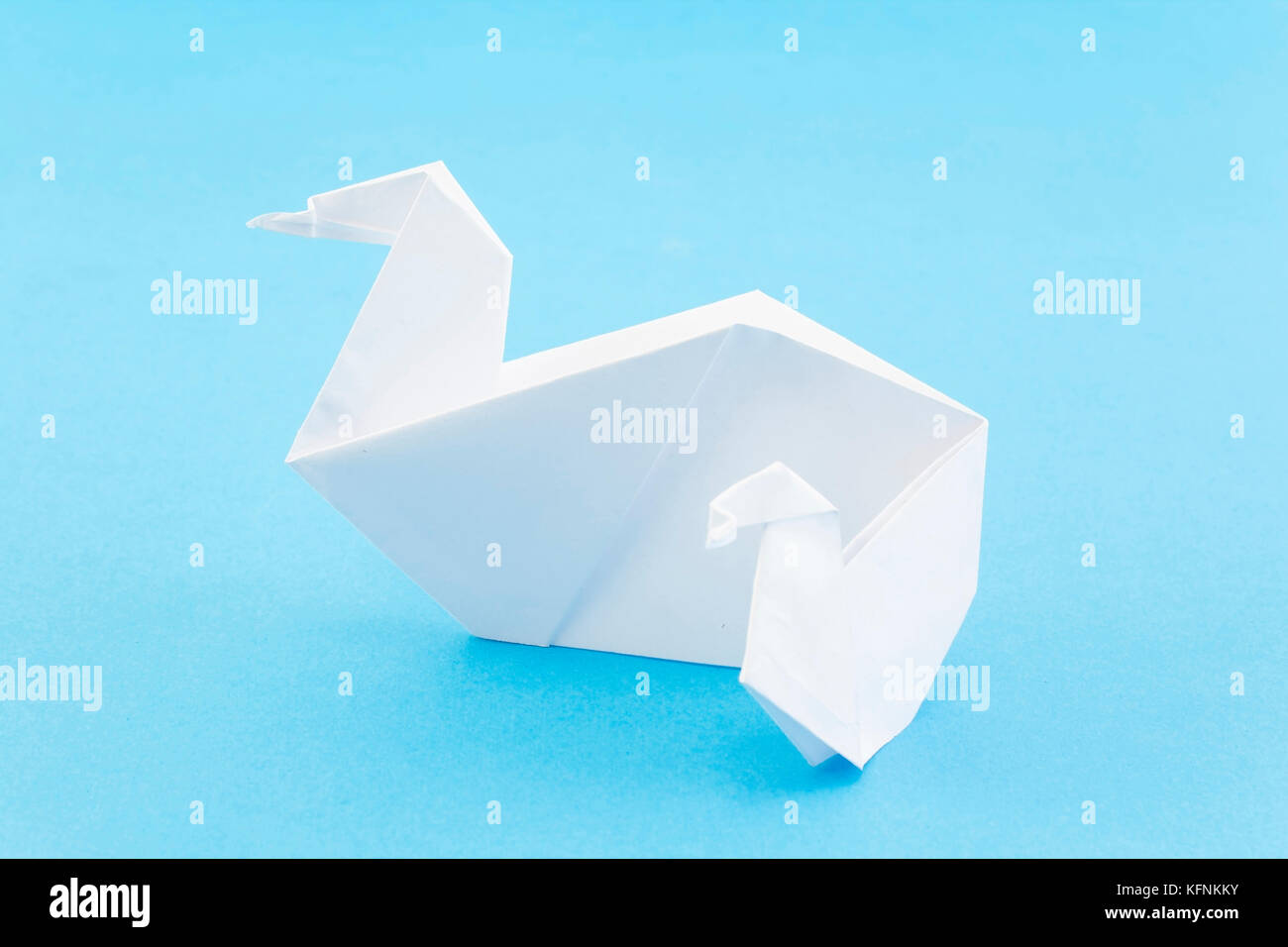 Origami Swans, Mother Swan and Cygnet on Blue Background Stock Photo ...