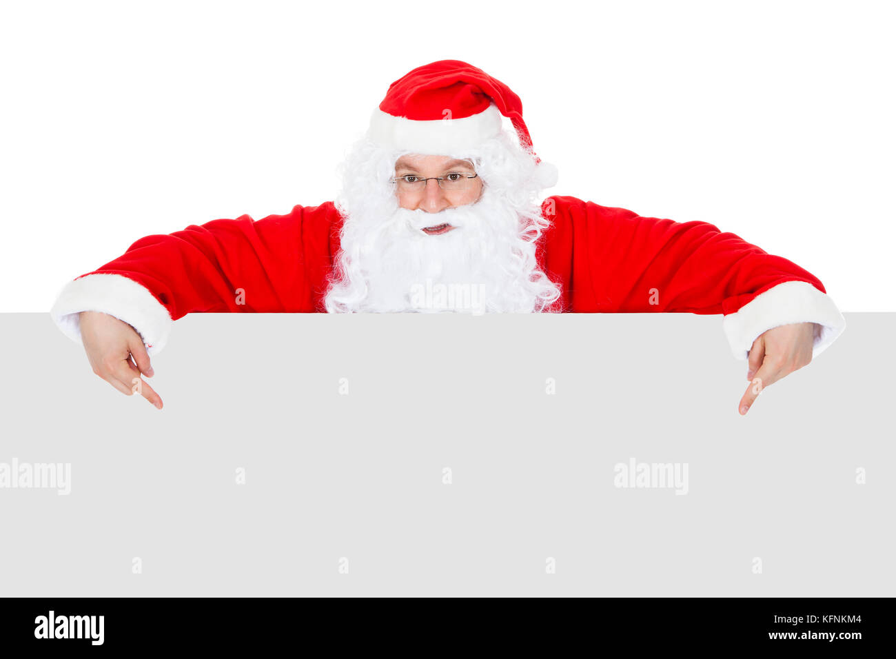 Portrait of a santa holding blank placard over white background Stock ...