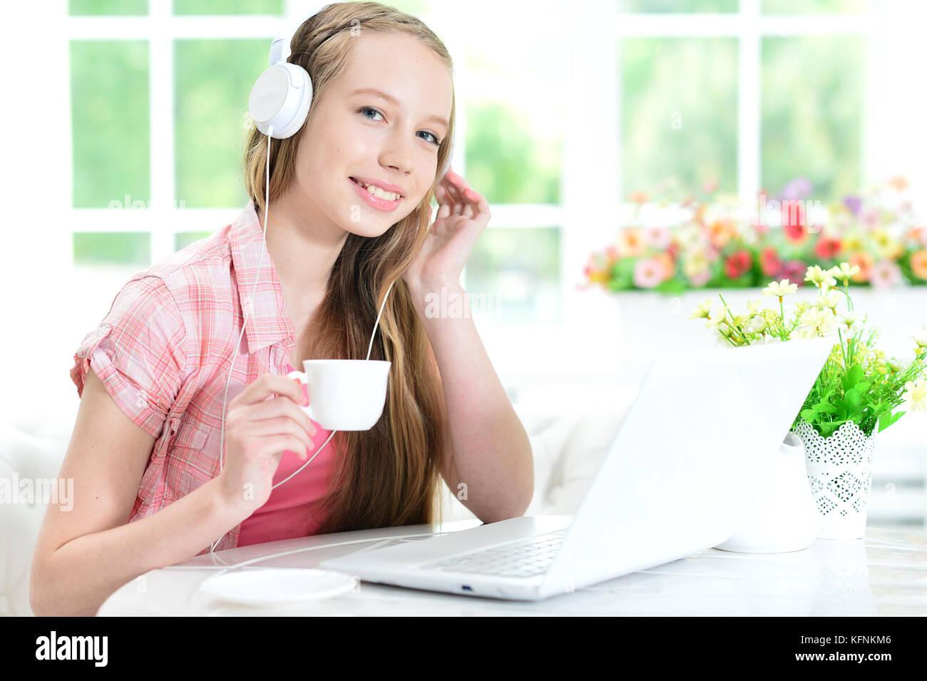 Teen girl using laptop Stock Photo - Alamy