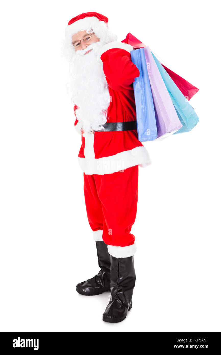 Portrait of santa holding shopping bag over white background Stock ...