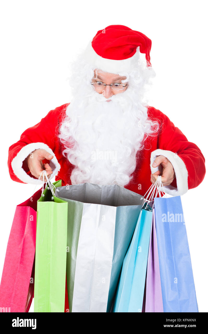 Surprised santa looking inside shopping bag on white background Stock ...