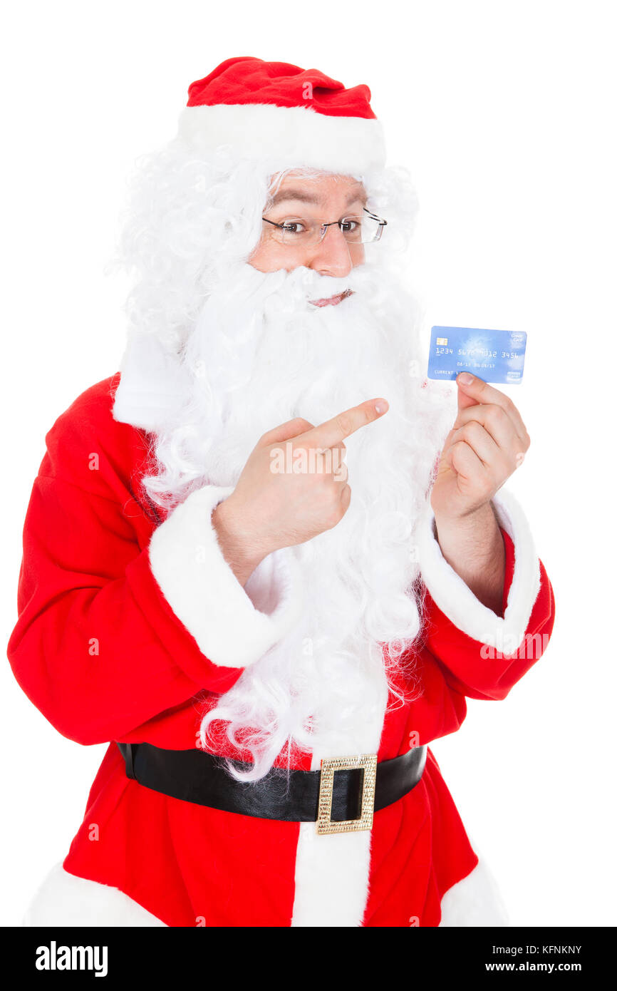 Portrait of santa pointing at credit card over white background Stock ...