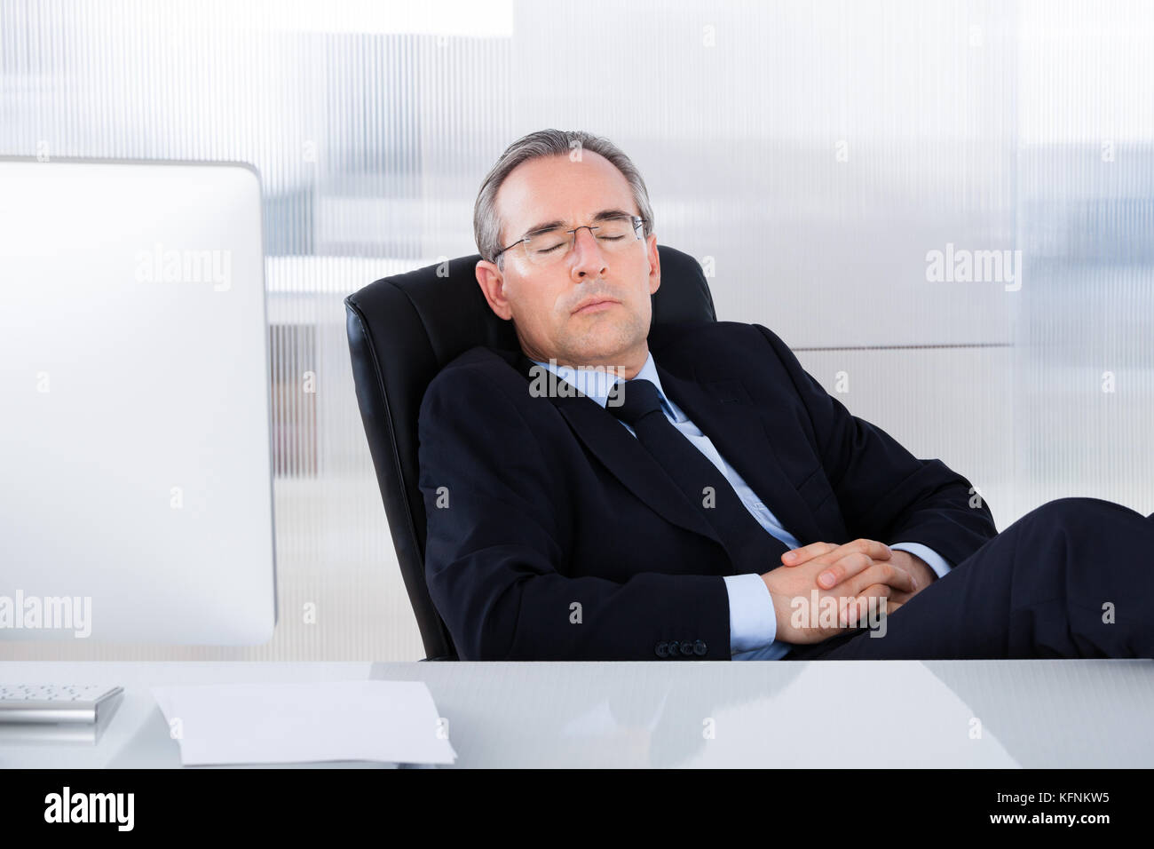 Mature Businessman Sleeping With Computer At Desk In Office Stock Photo ...