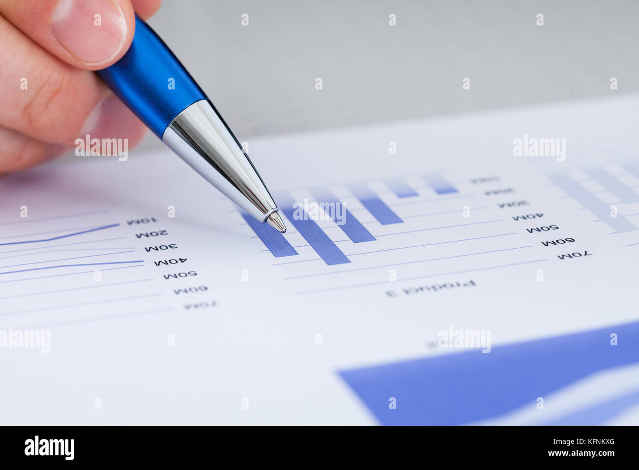 Close-up Of Hand Holding Pen Over Graph Stock Photo - Alamy