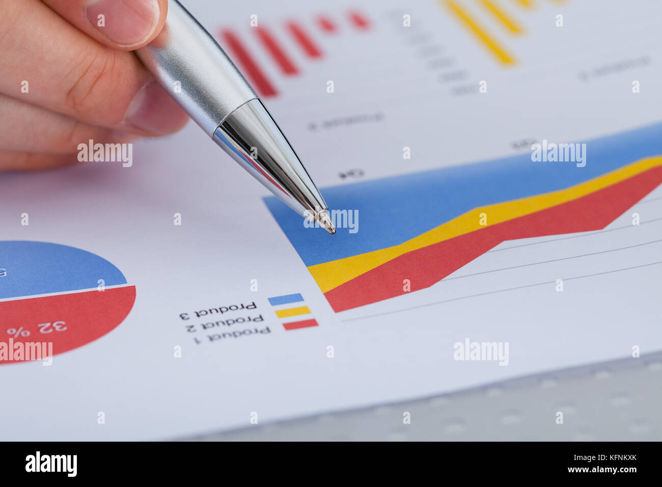 Close-up Of Hand Holding Pen Over Graph Stock Photo - Alamy