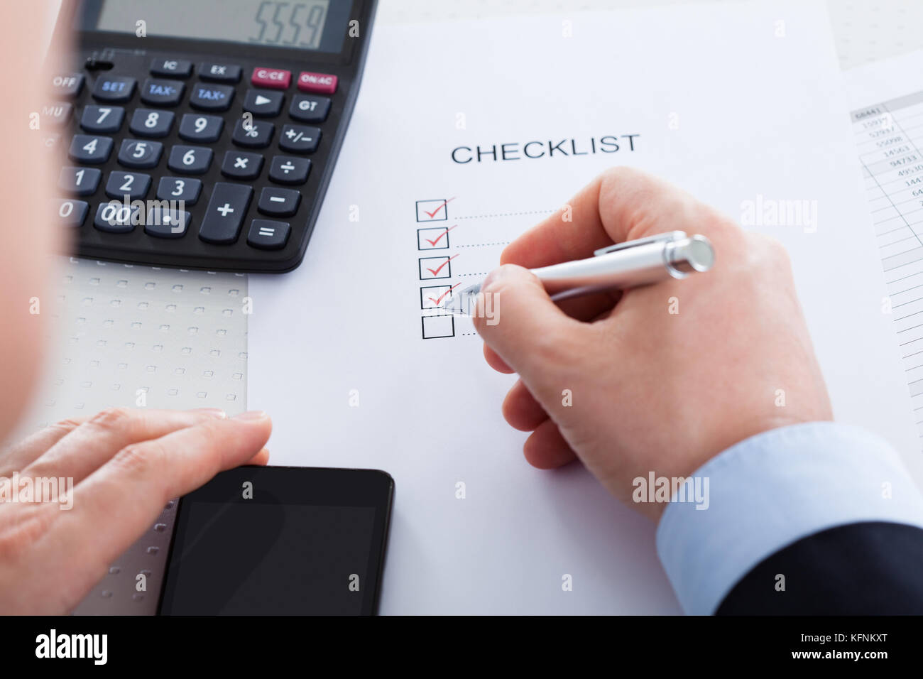 Close-up Of Hand Holding Pen Over Application Form With Mobile Phone ...