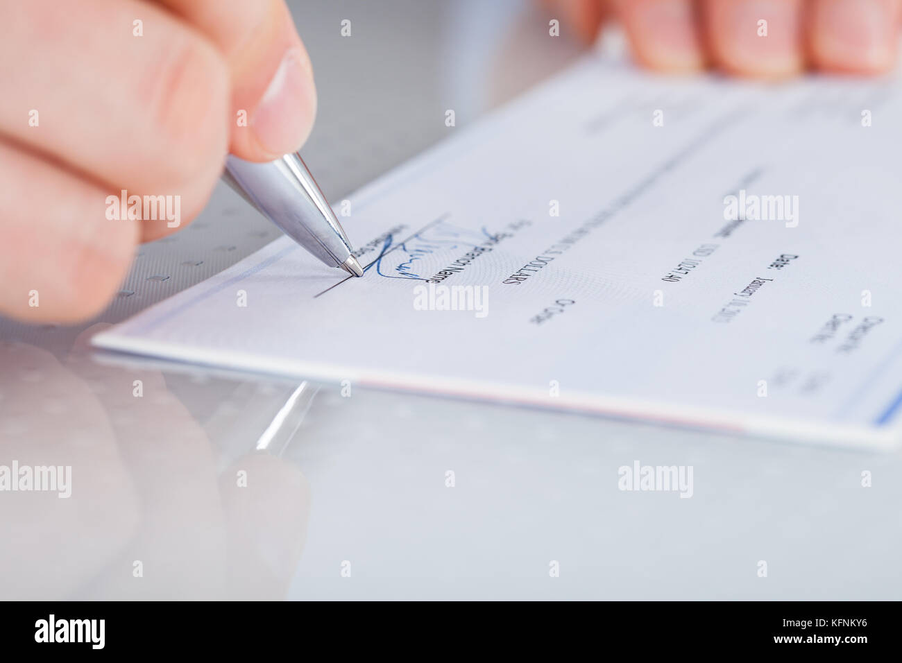 Close-up Of Hand Holding Pen Preparing Writing Check Stock Photo - Alamy