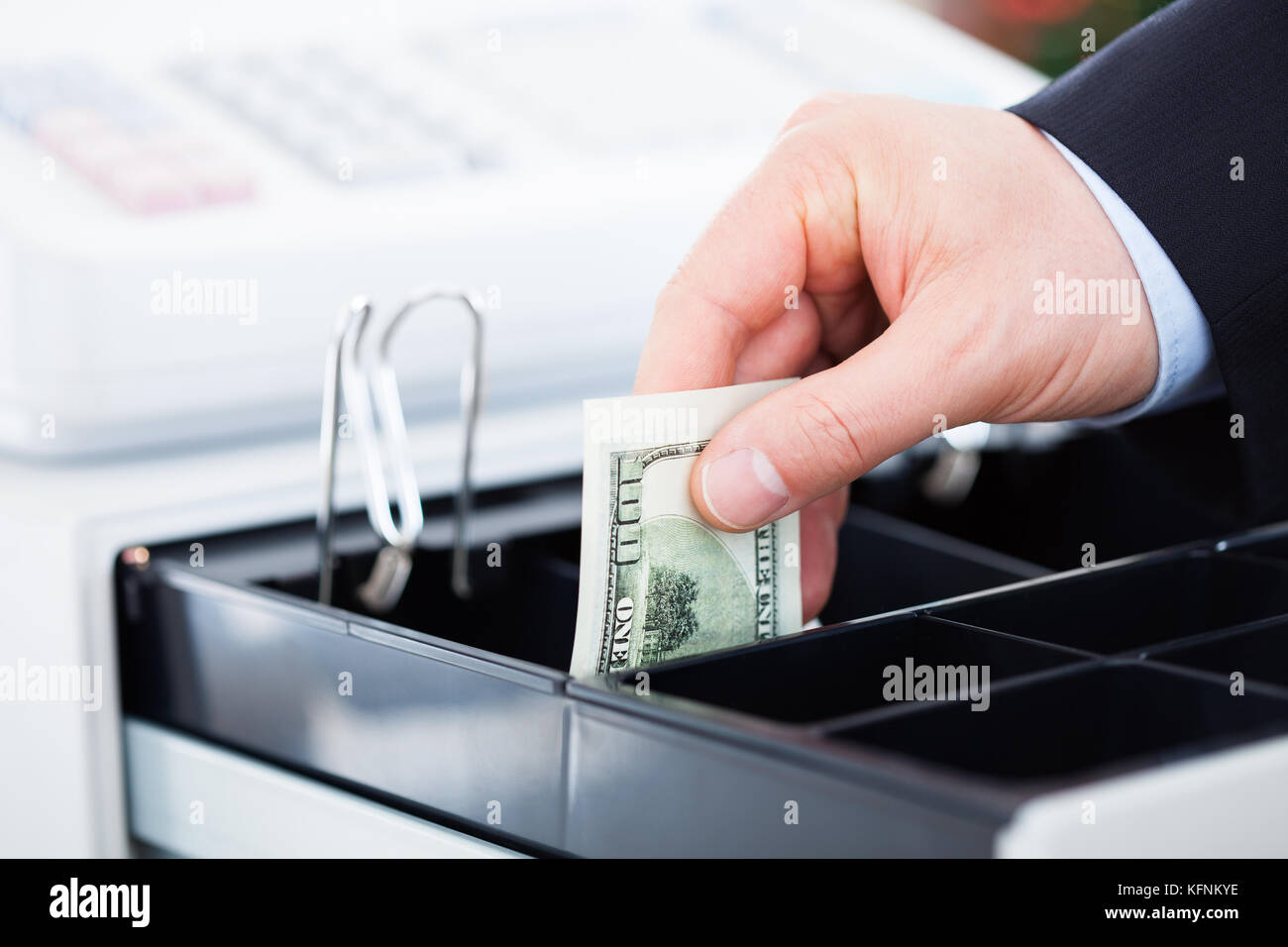 Close-up Of Hand With Dollar Notes Over Container Stock Photo - Alamy