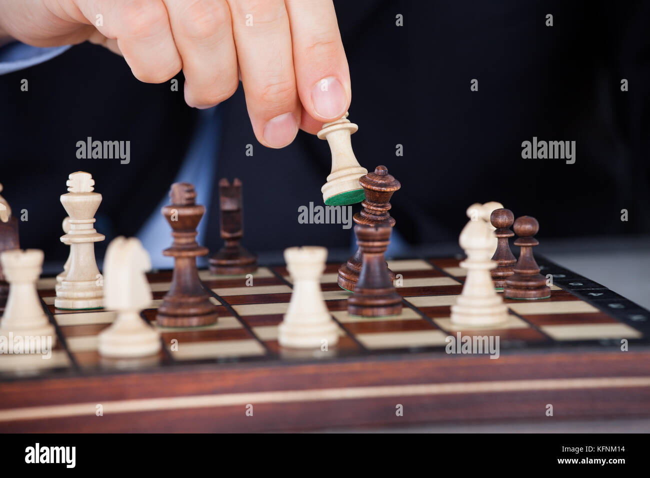 Close-up of a human hand playing chess Stock Photo - Alamy